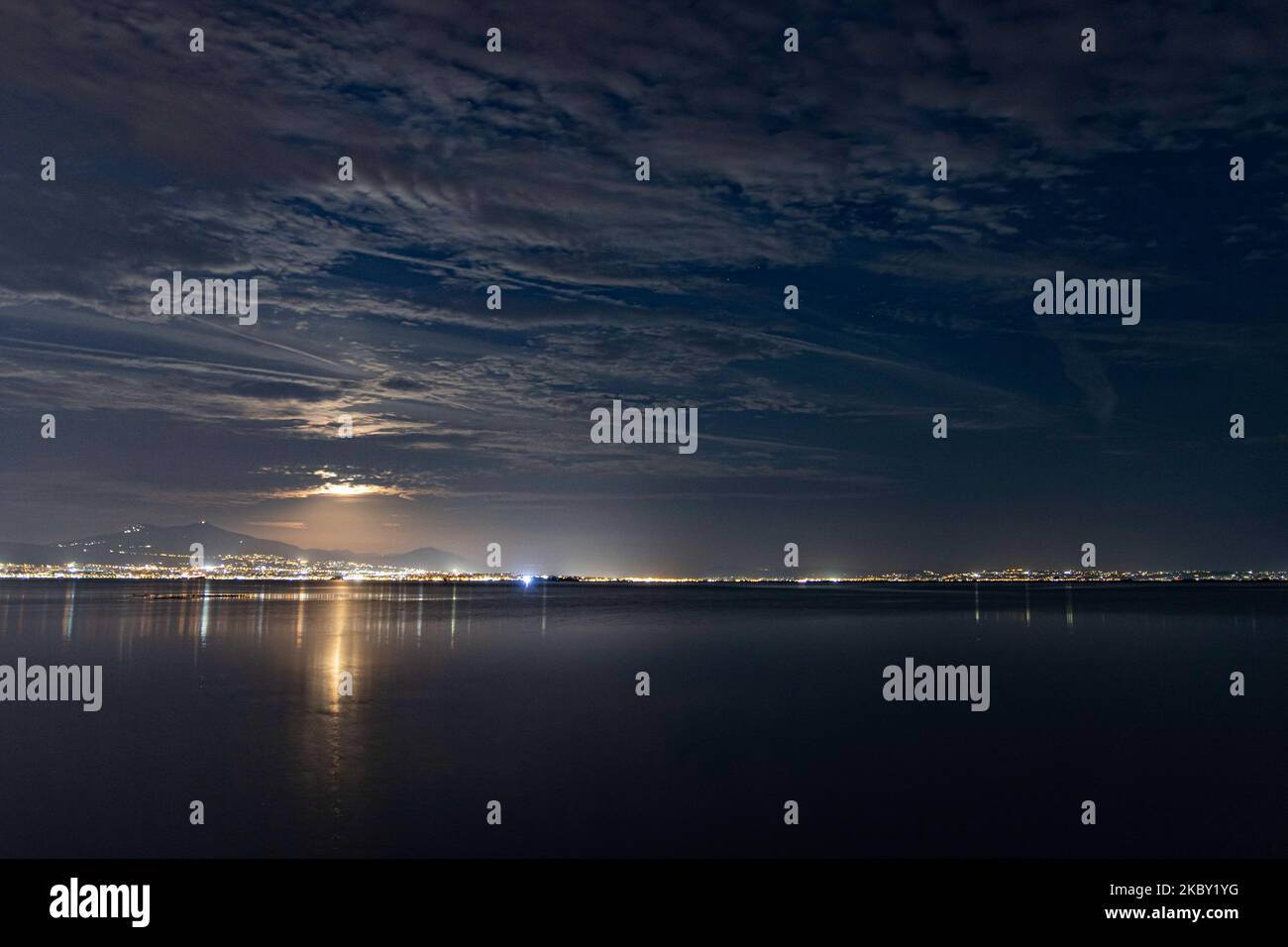 The Full Corn Moon as seen behind Hortiatis mountain over the city of ...