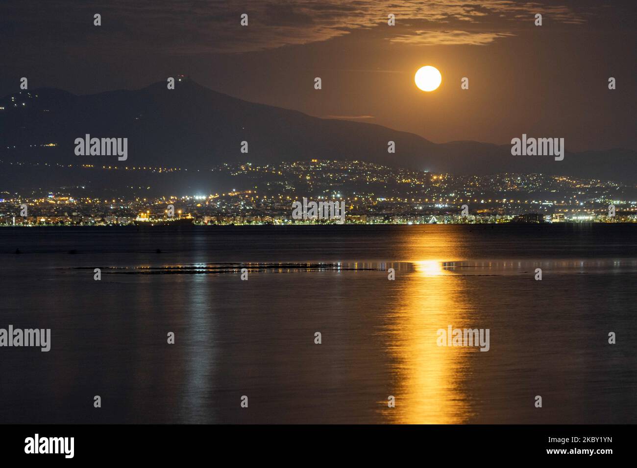 The Full Corn Moon as seen behind Hortiatis mountain over the city of ...