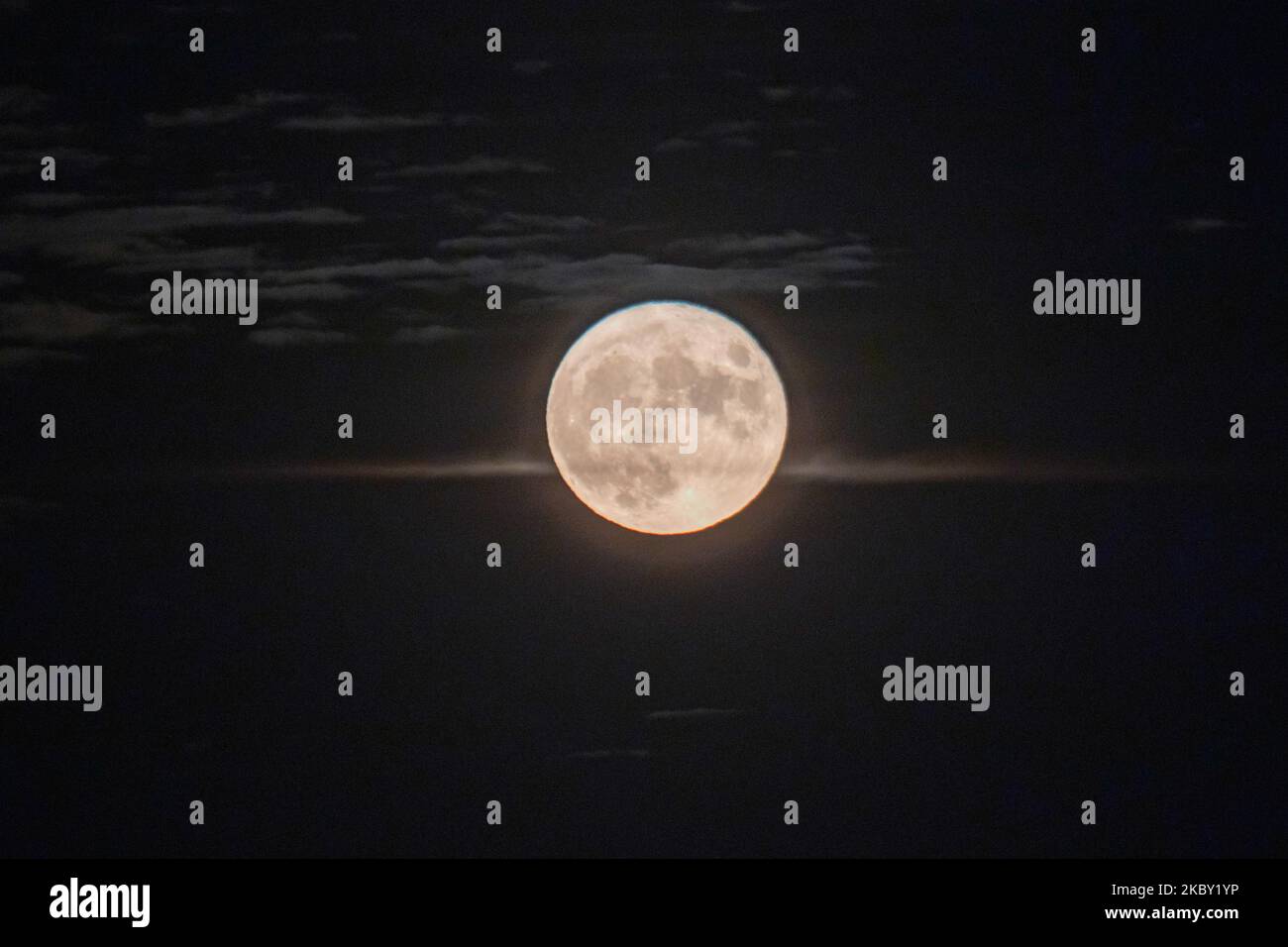 The Full Corn Moon as seen behind Hortiatis mountain over the city of ...