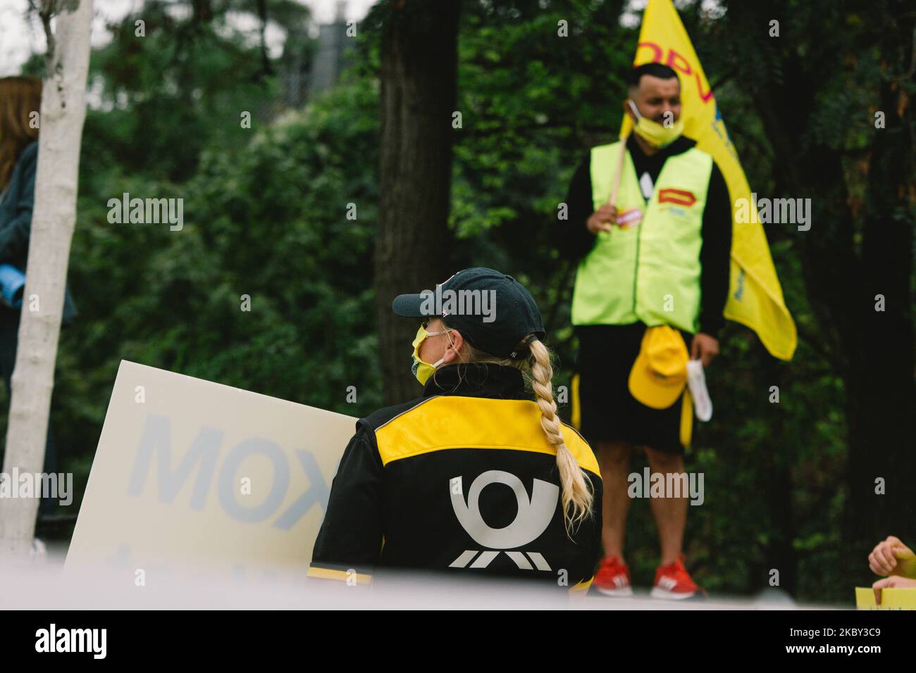 A protest wears deutsche post uniform during the protest in front of ...