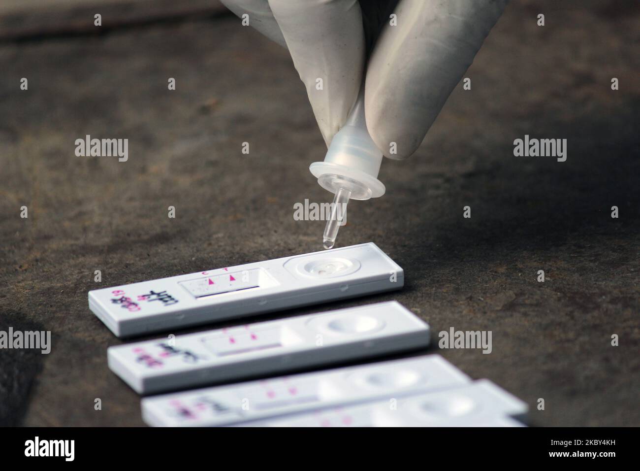 Testing kits are seen after collecting swab sample from patients for ...