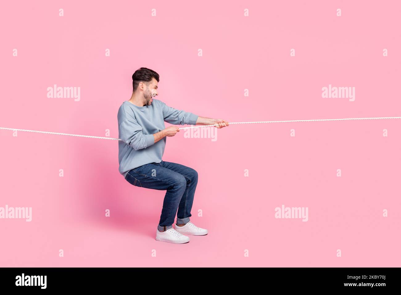 Profile side full body photo of determined guy leader fight tug war ...