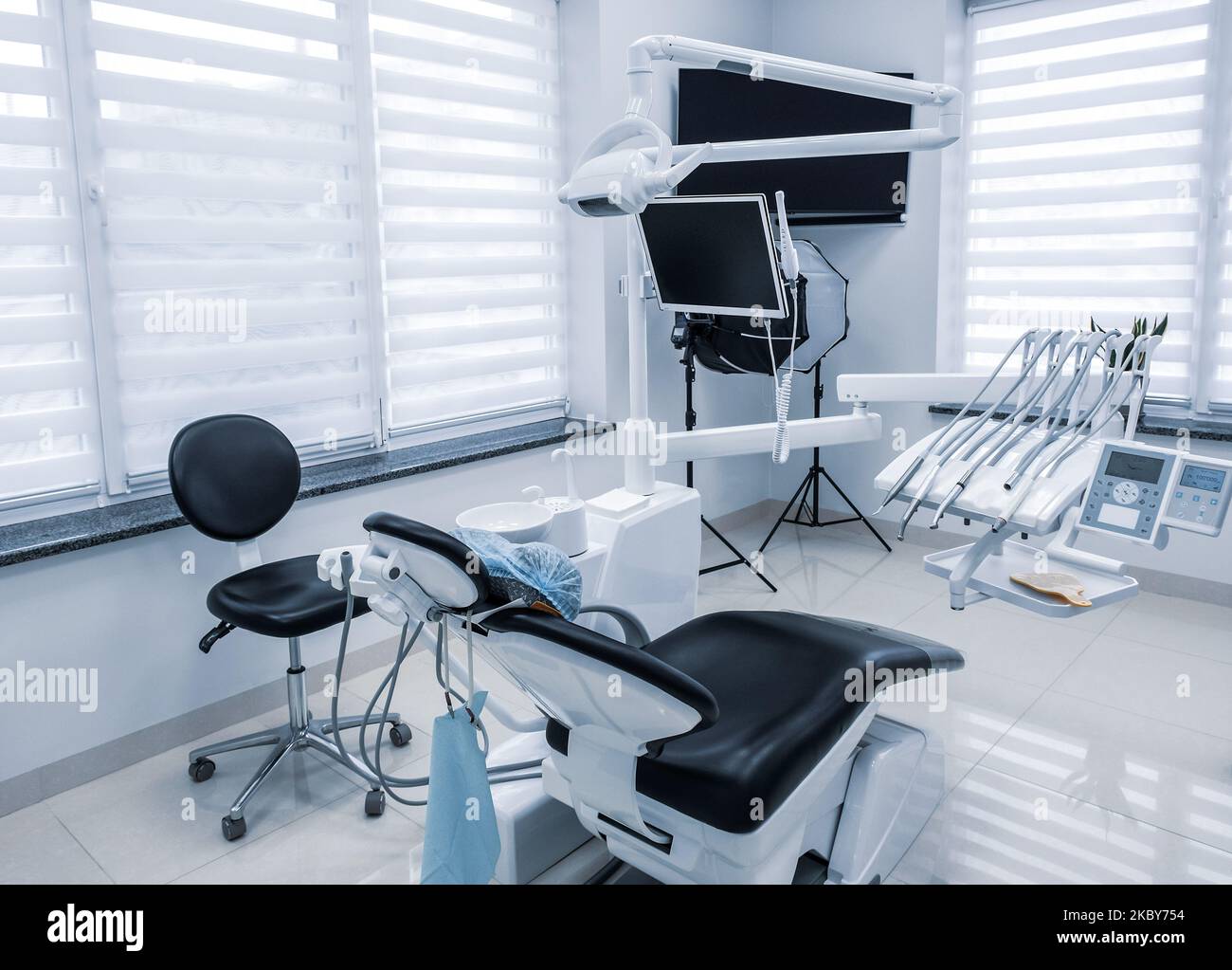 Dental clinic interior with working tools. Dental chair and other ...