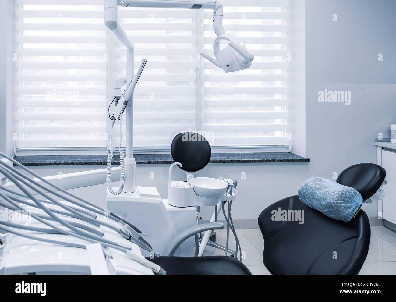 Dental clinic interior with working tools. Dental chair and other ...