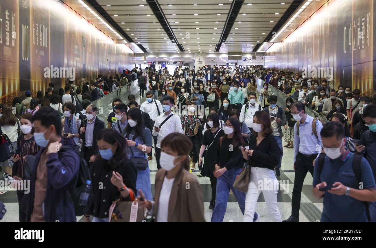 Commuters wearing protective face masks walking on MTR Central station ...