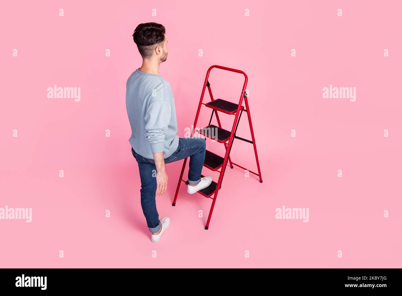 Full body photo high angle view of nice young man step ladder lifting ...