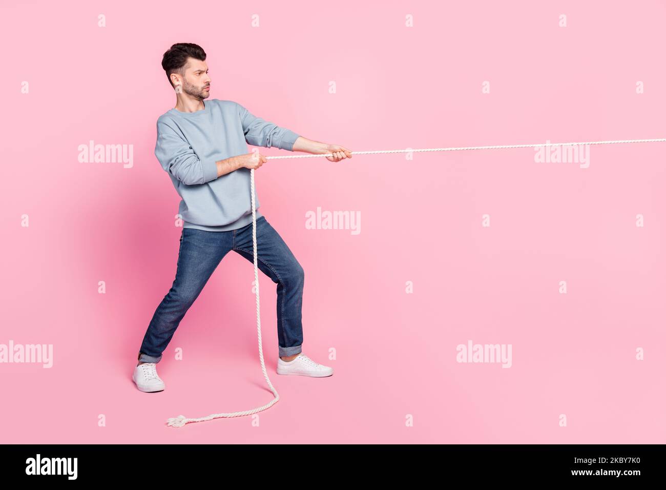 Profile side full body photo of guy pulling string have victory ...