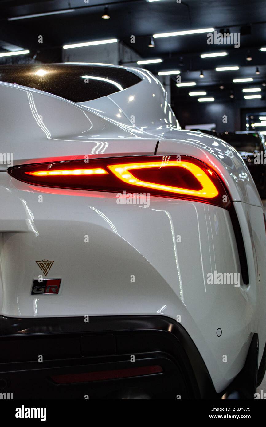 A vertical shot of the rear part of a white Toyota Supra A90 with an ...