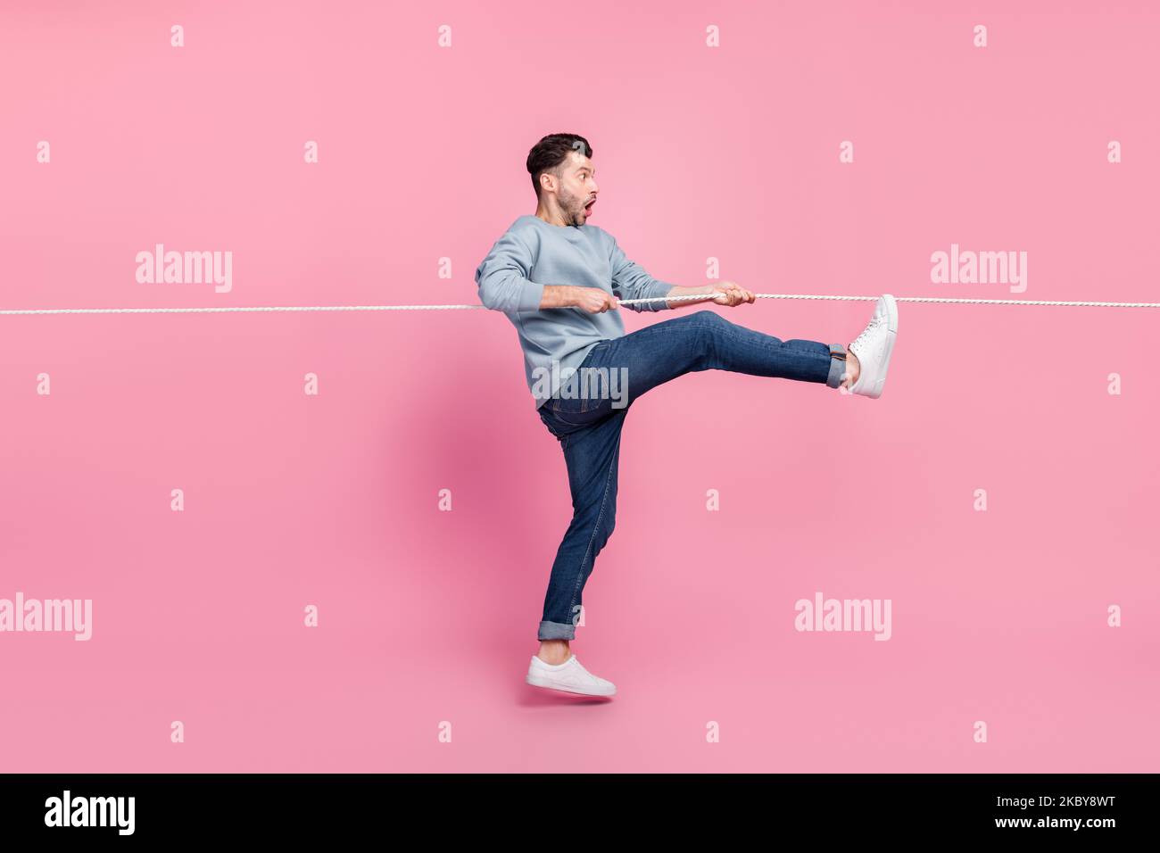 Profile side photo of impressed guy competitor jump up pull string ...