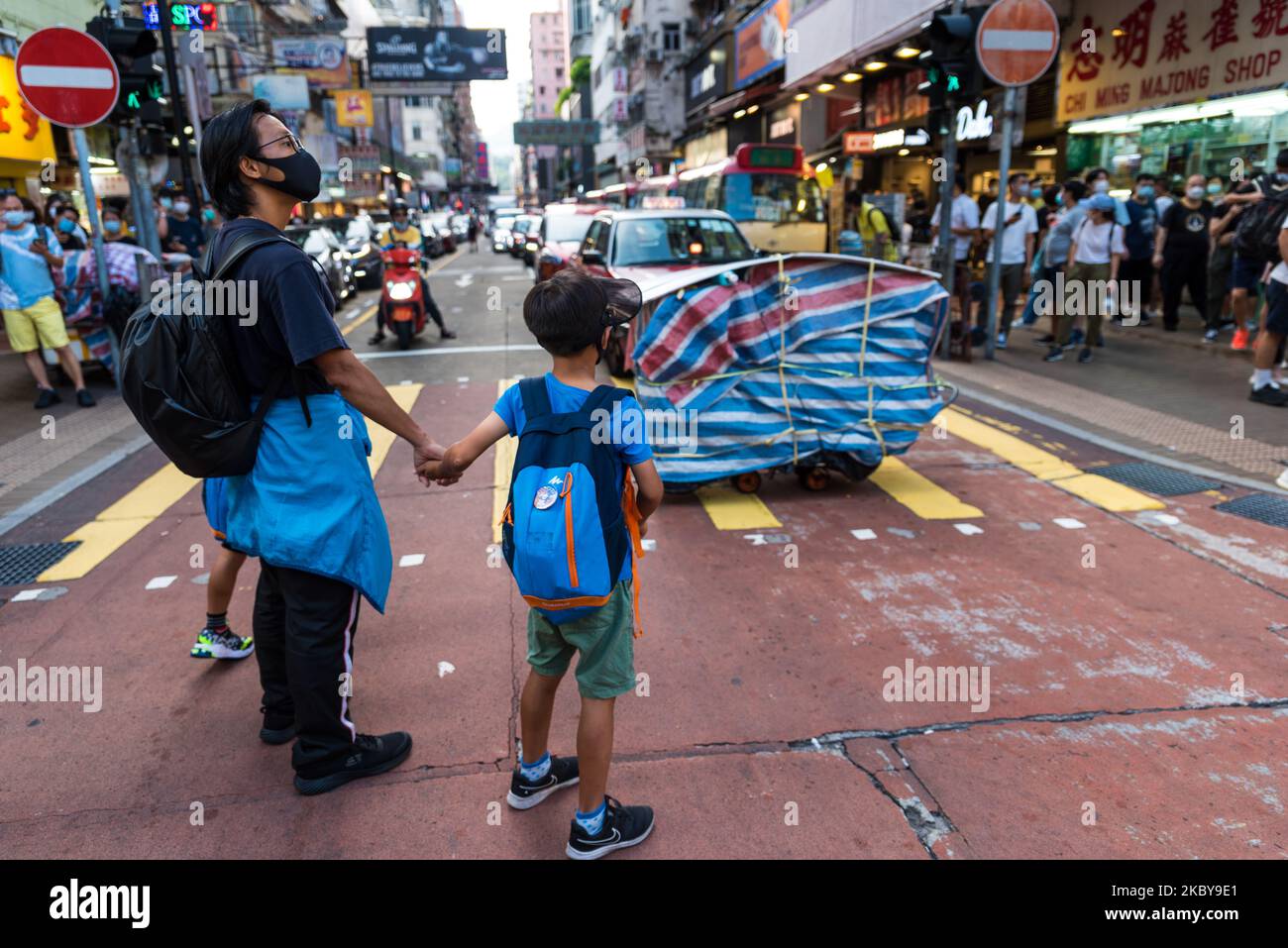 A father and his two sons survey the scene as Sai Yeung Choi South ...