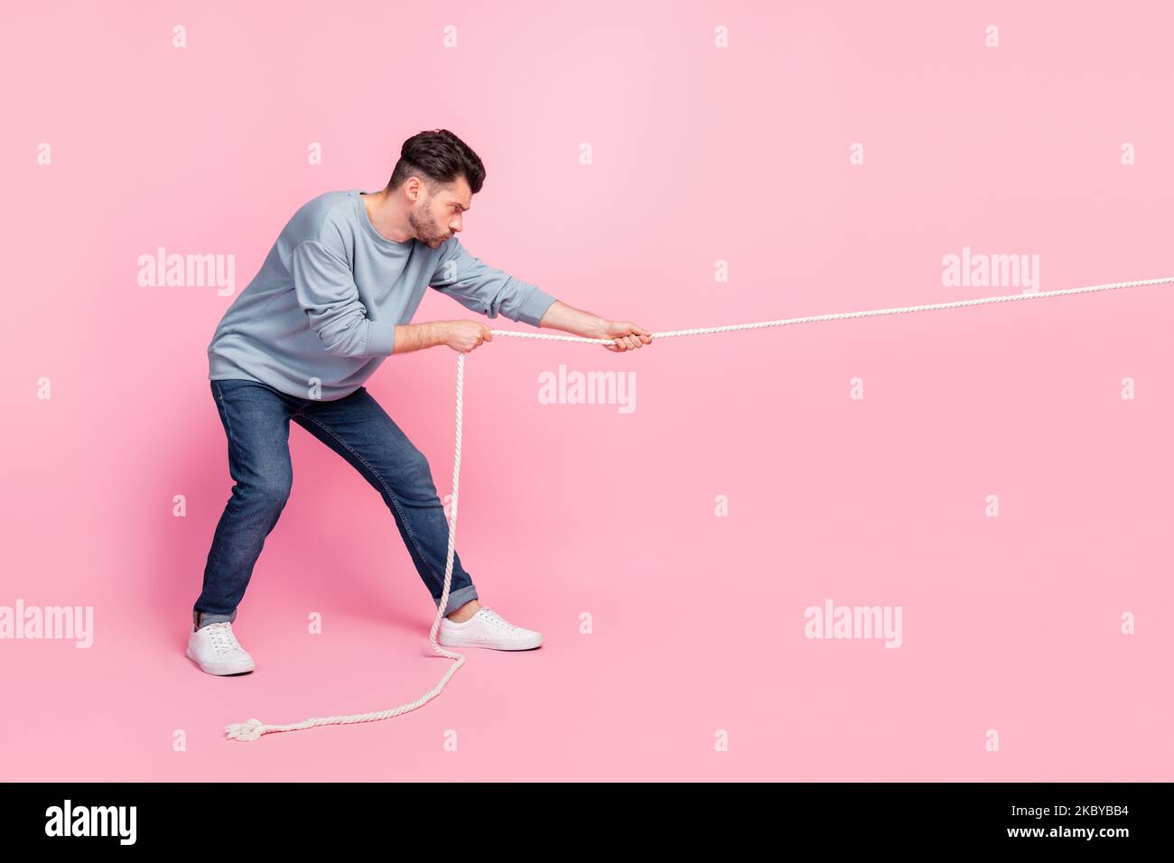 Profile side full length photo of determined guy ready pull string tug ...