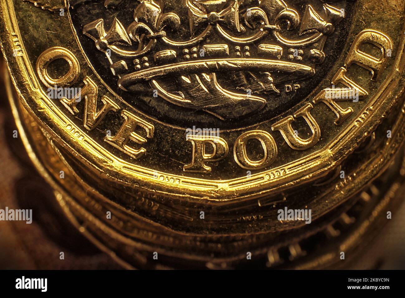 Close up detail of British UK One pound Coin on top of a pile of coins ...