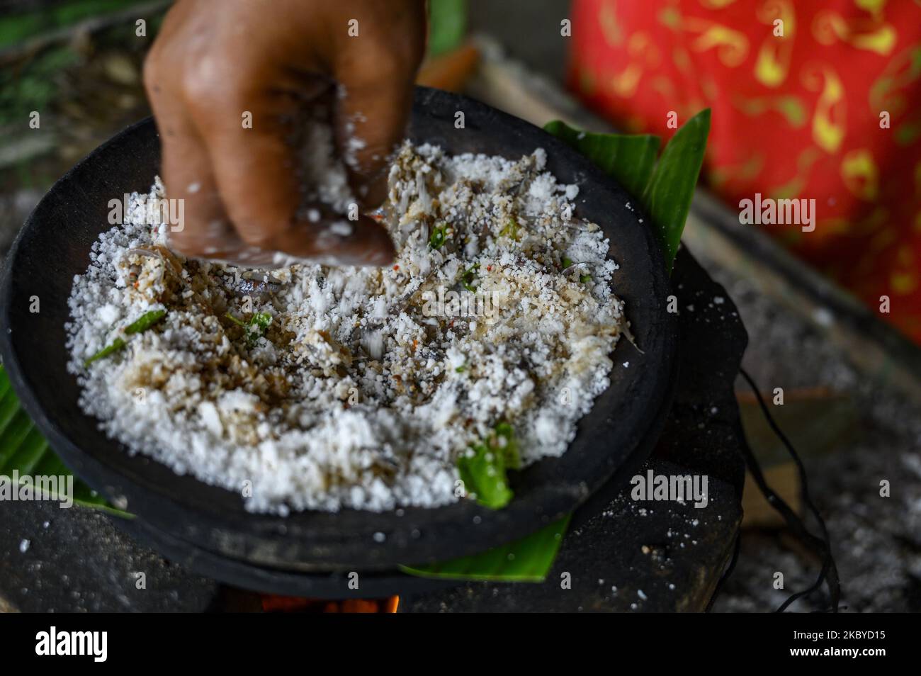 A mother cooks a typical Tolitoli ambal in Baru Village, Tolitoli ...
