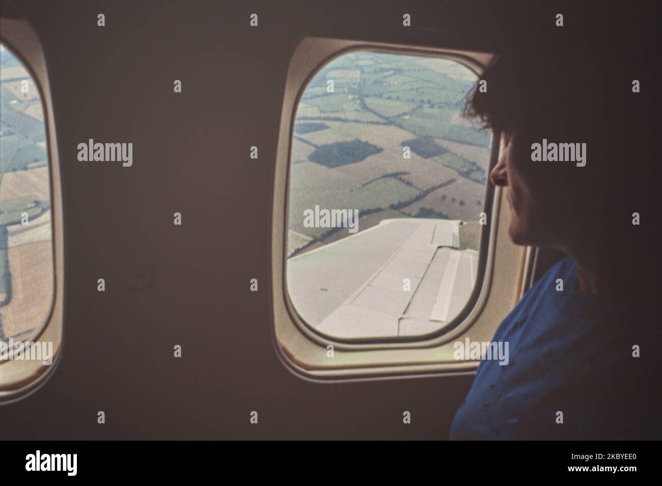 Paris, France may 1979: Woman looks outdoor from the plane window scene ...