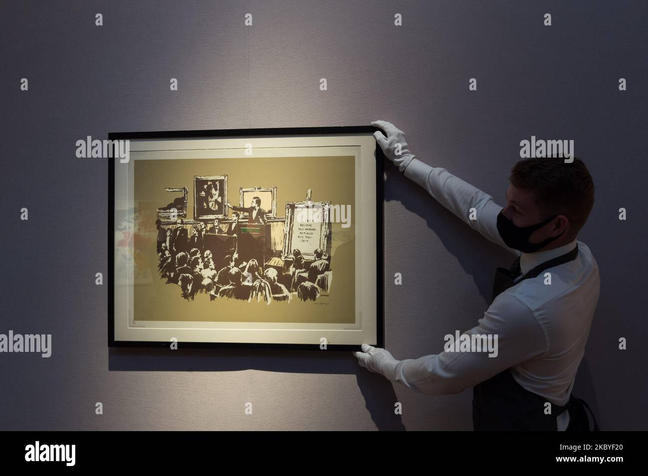 (EDITOR'S NOTE: Editorial use only) A staff member poses with 'Morons ...