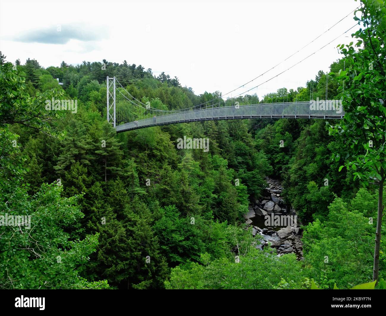 The hanging footbridge crossing over the Coaticook River in Quebec ...