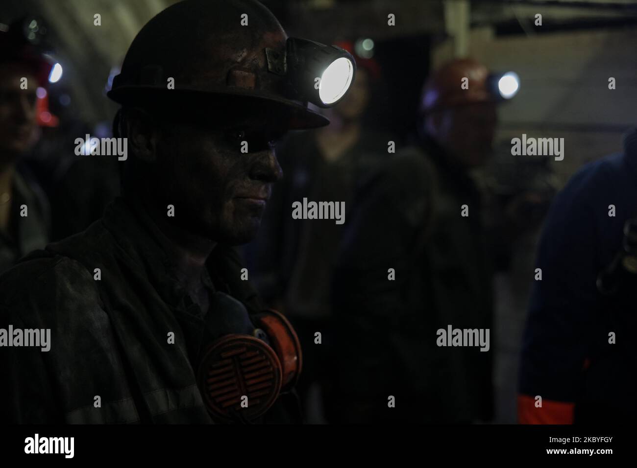 The miners wait to leave the mine after the working day at the bottom ...