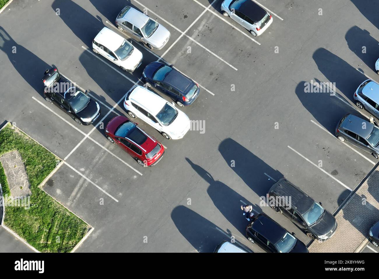 Aerial view of many colorful cars parked on parking lot with lines and ...