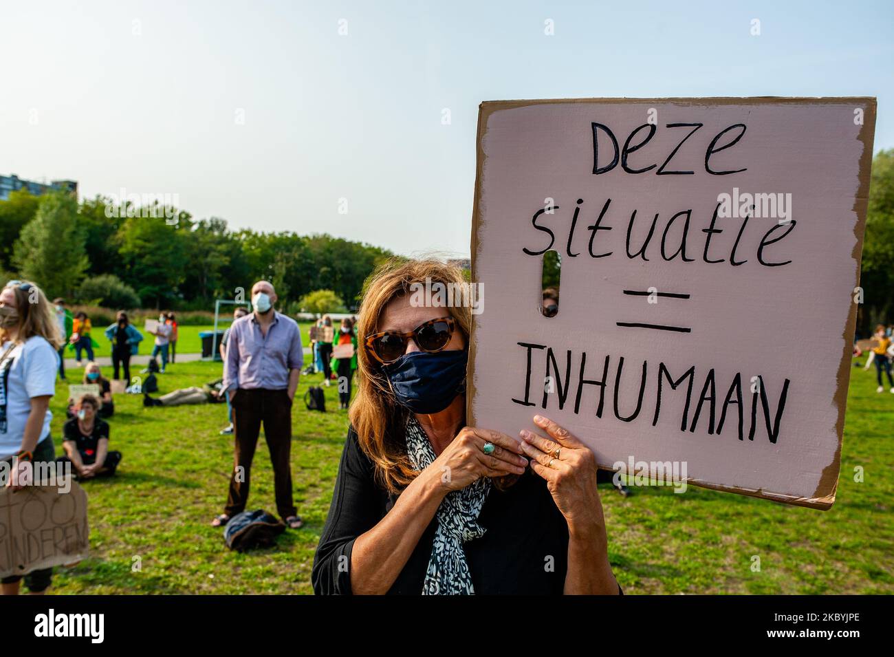 A woman is holding a big pro human rights placard, during the ...