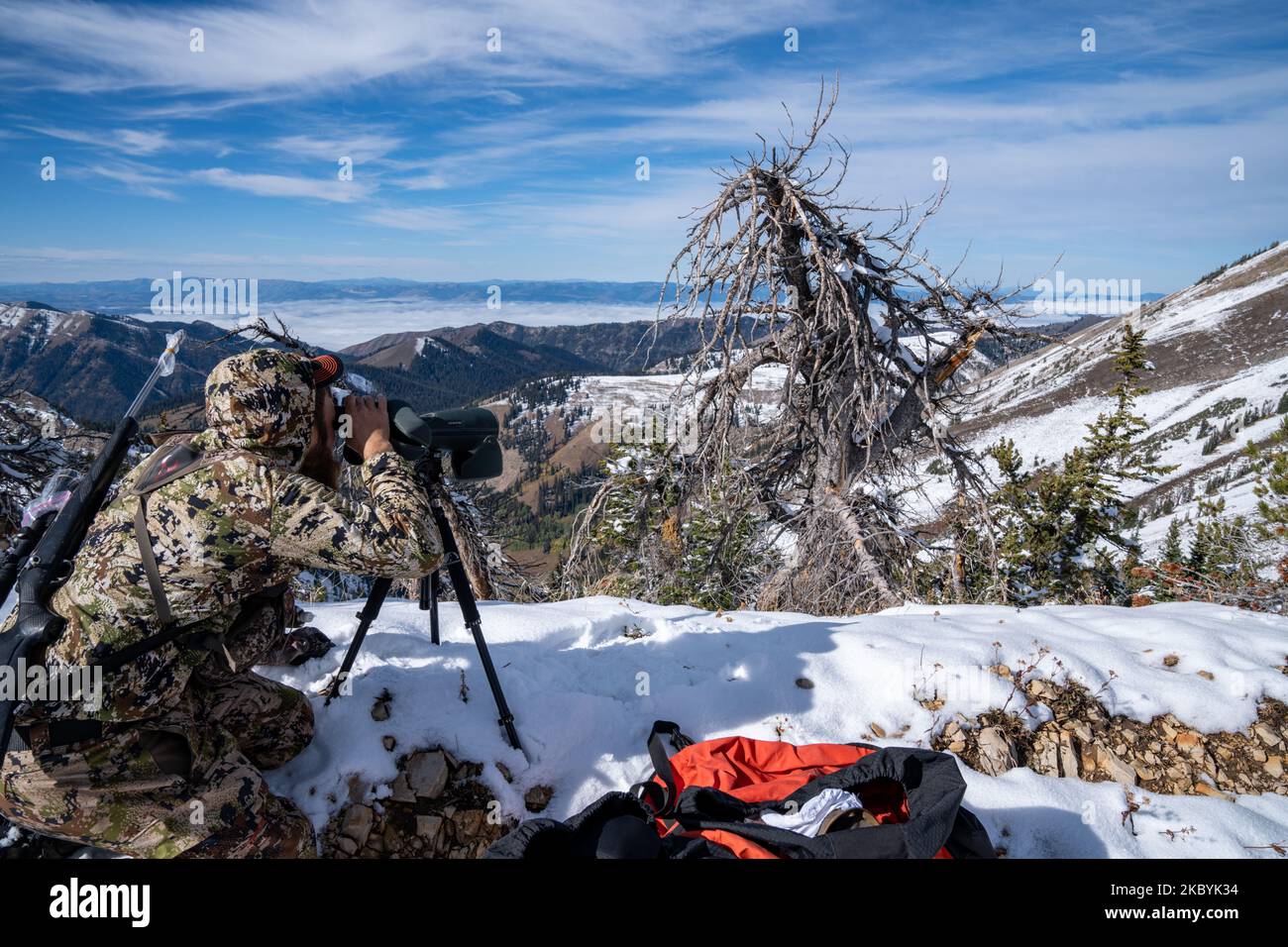 Wyoming, USA - October 2, 2022: Hunter wearing camo uses a spotting ...