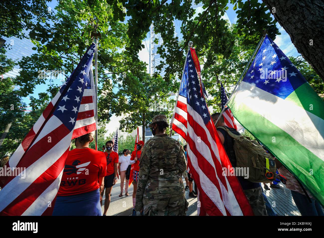 US veterans holding american flags during a 9/11 memorial service at ...