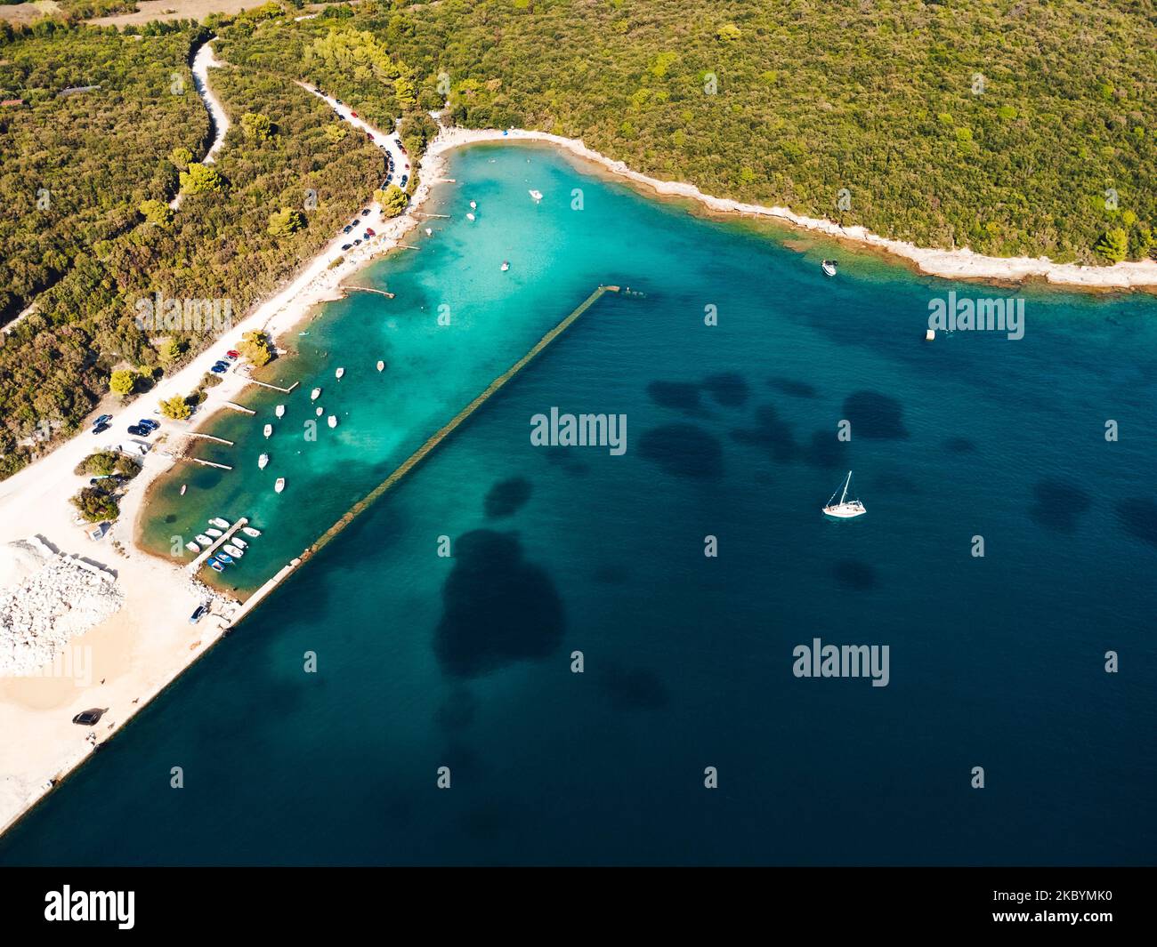 A mesmerizing aerial view of the azure sea next to the forest, Croatia ...