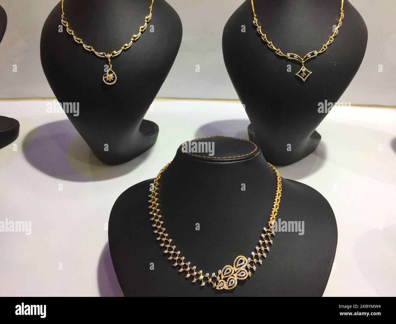 Gold and diamond necklaces displayed at a jewelry shop in the city of ...