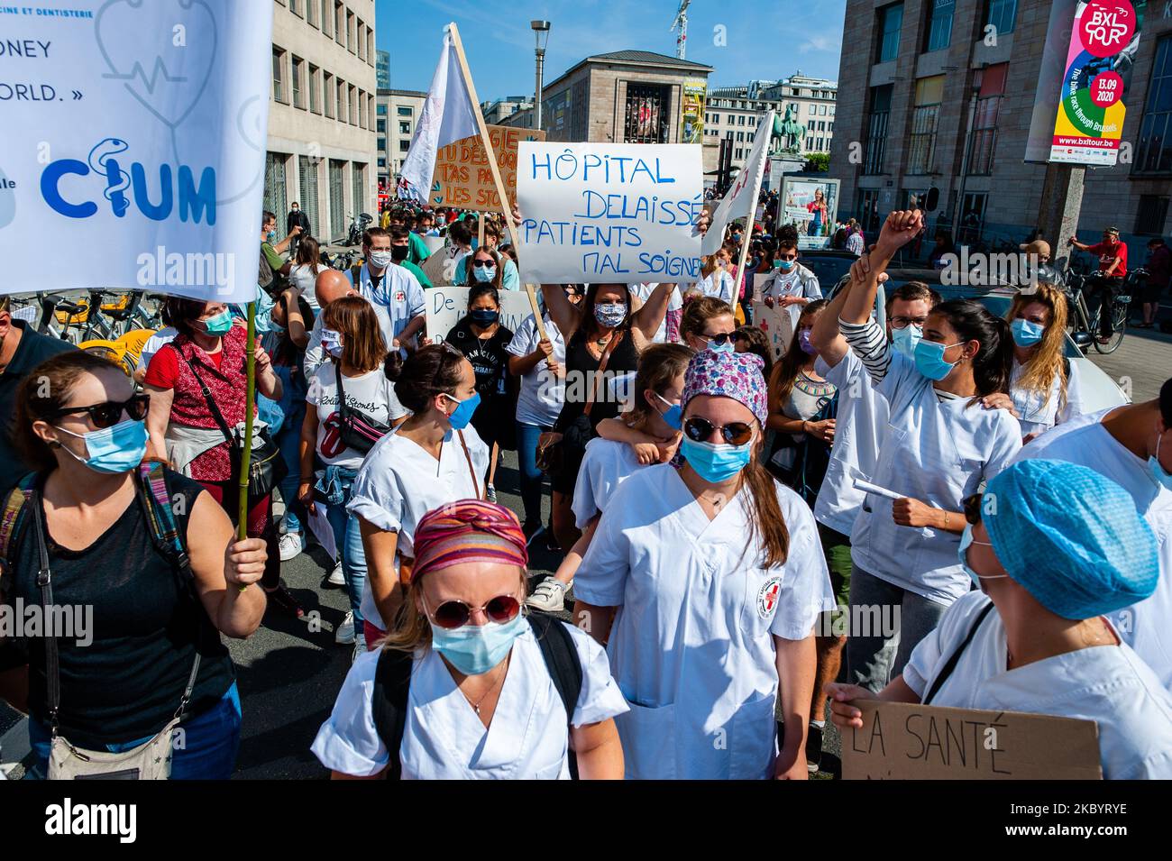 Hospital workers are holding placards for a better health care system ...