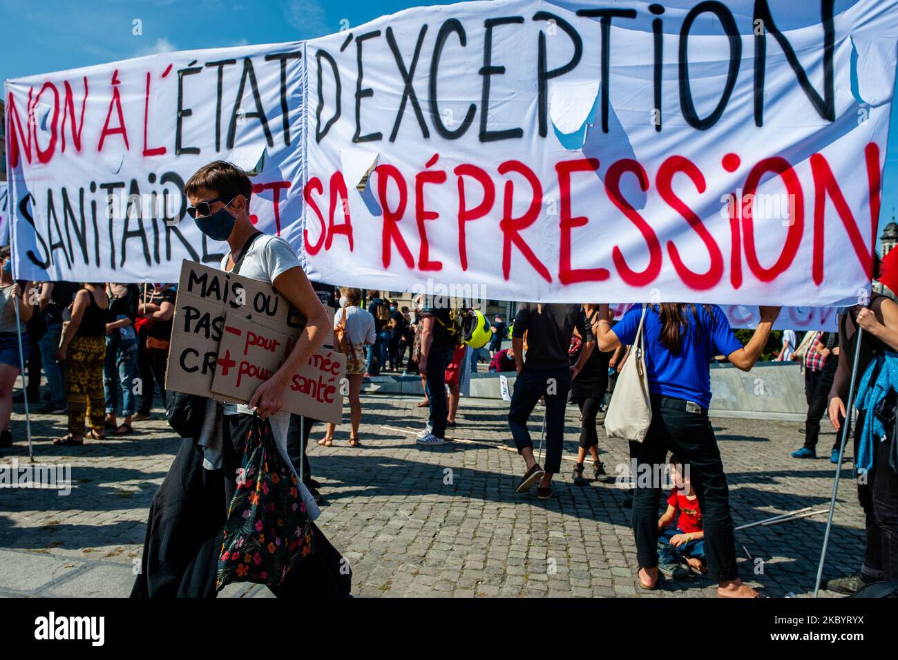 A woman is passing in front of a big banner, during the Belgian health ...