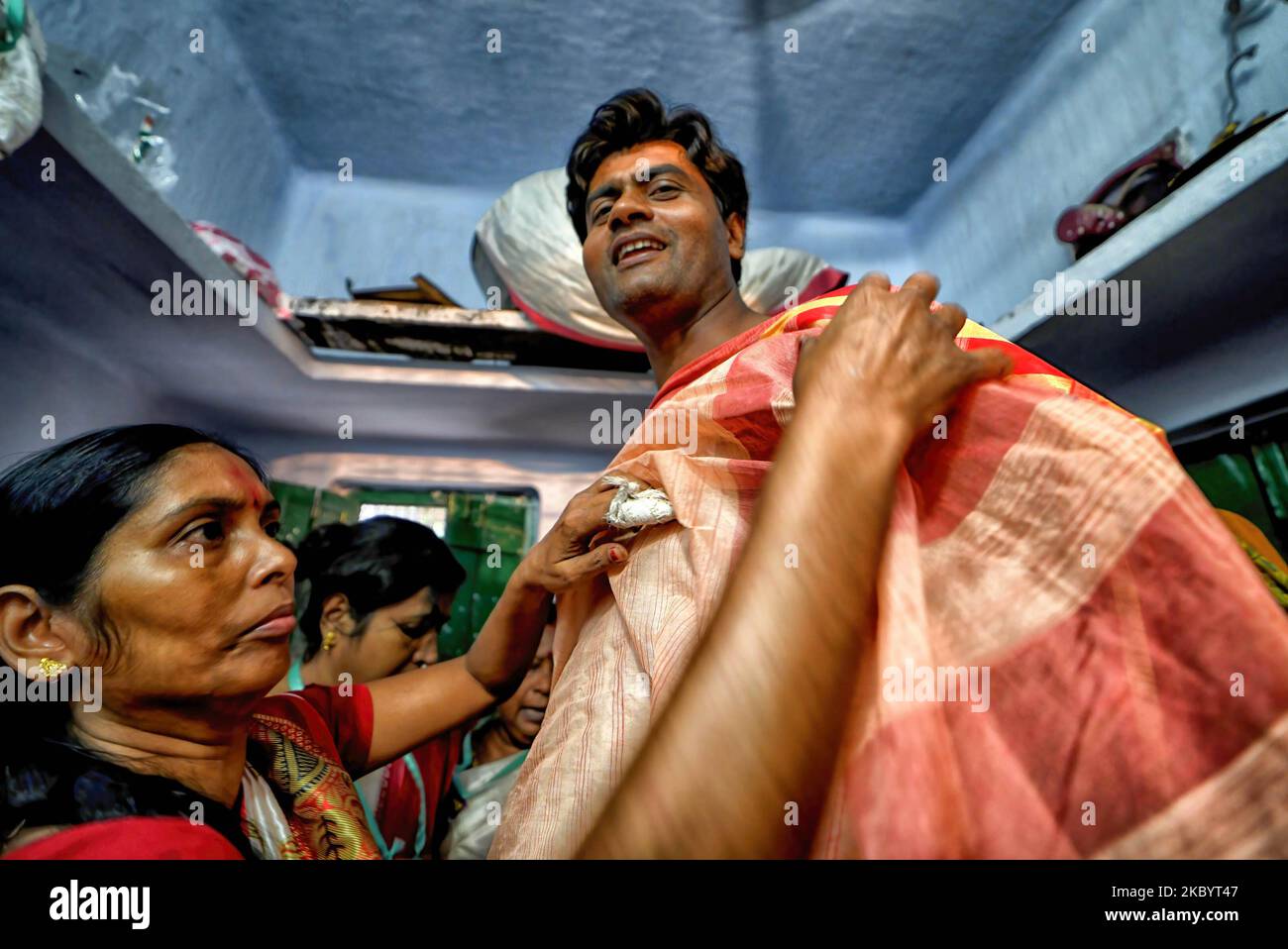A Hindu man seen dressed up as a woman (saree) during jagadhatri puja ...