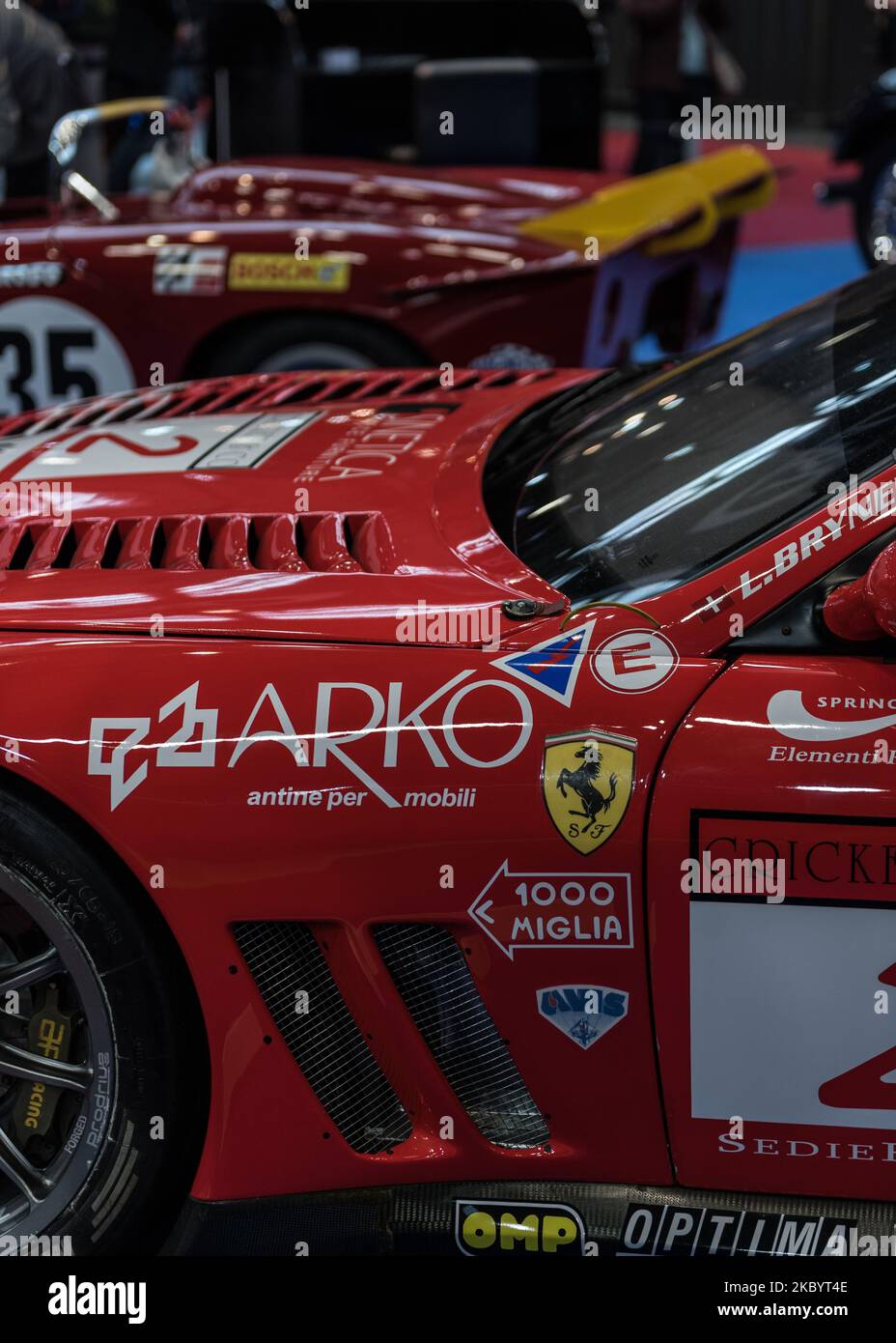A vertical shot of the fender of a red Ferrari racecar with a red ...
