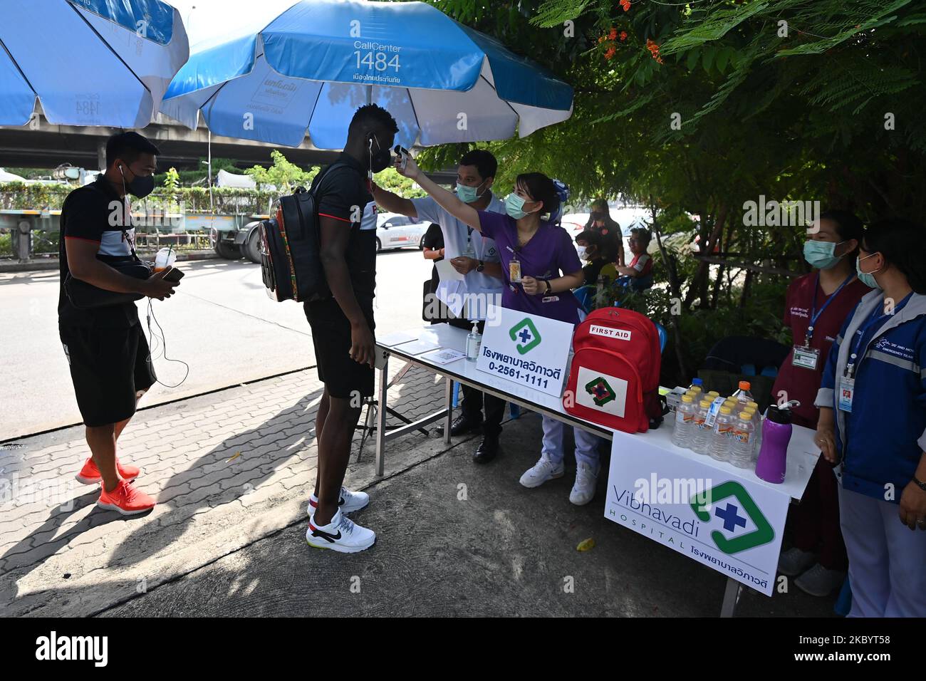 A health worker checks the temperature of a players of Police Tero FC ...