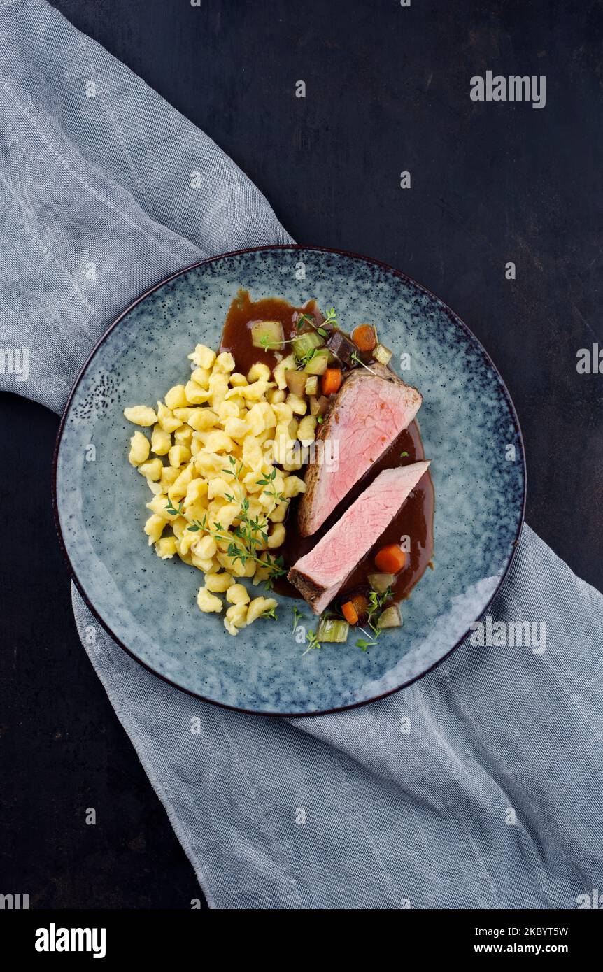 Tafelspitz roast veal slices with Swabian spaetzle and vegetable served ...