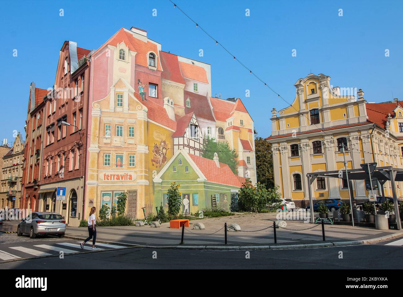Giant mural named ' Srodka story with a bugler on the roof and a cat in ...
