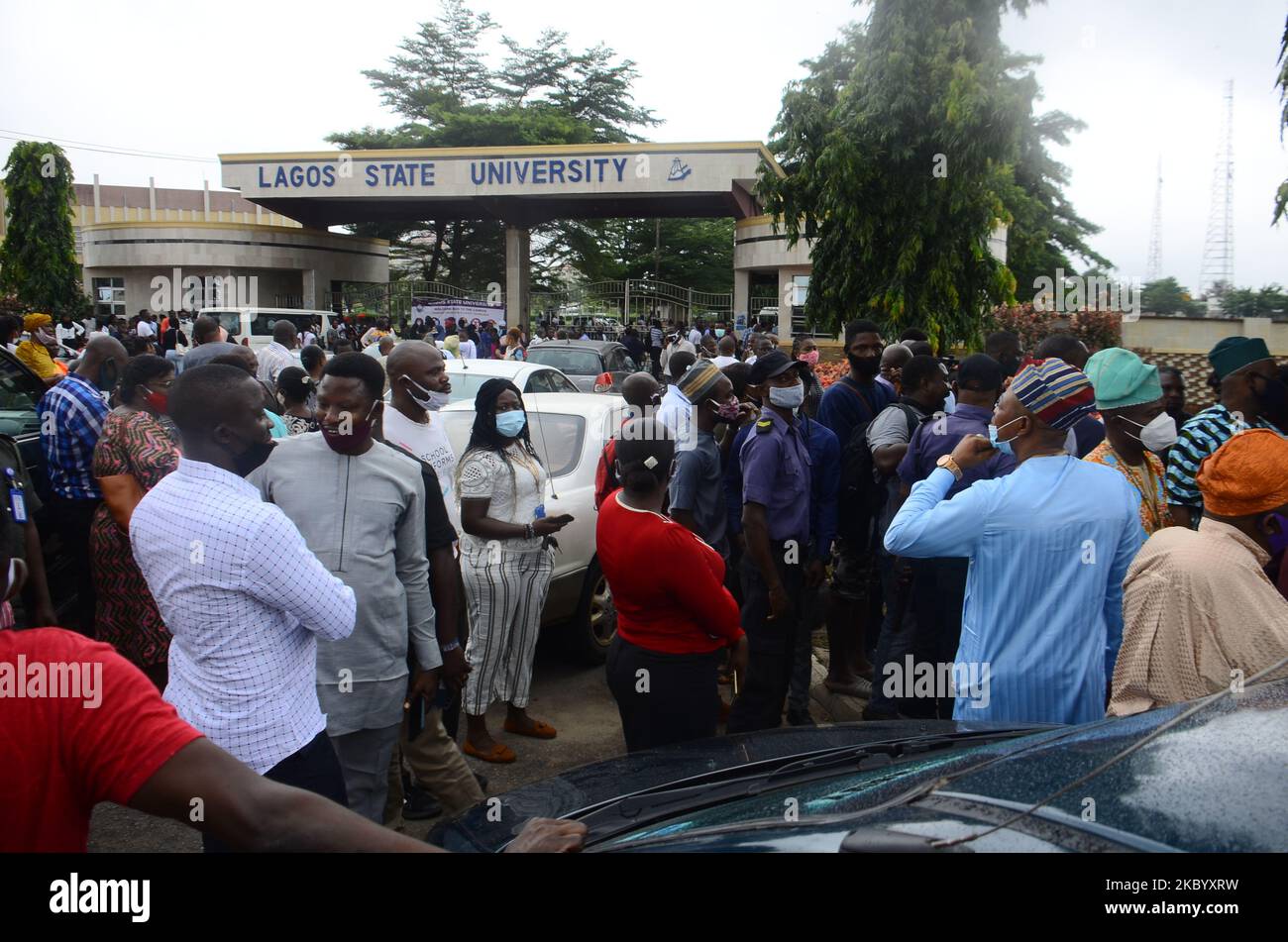 Students and lecturers of Lagos State University wait out the school gate as The Academic Staff ...