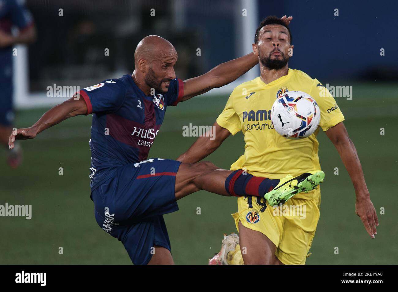 Mikel Rico of Huesca and Francis Coquelin of Villarreal compete for the ...