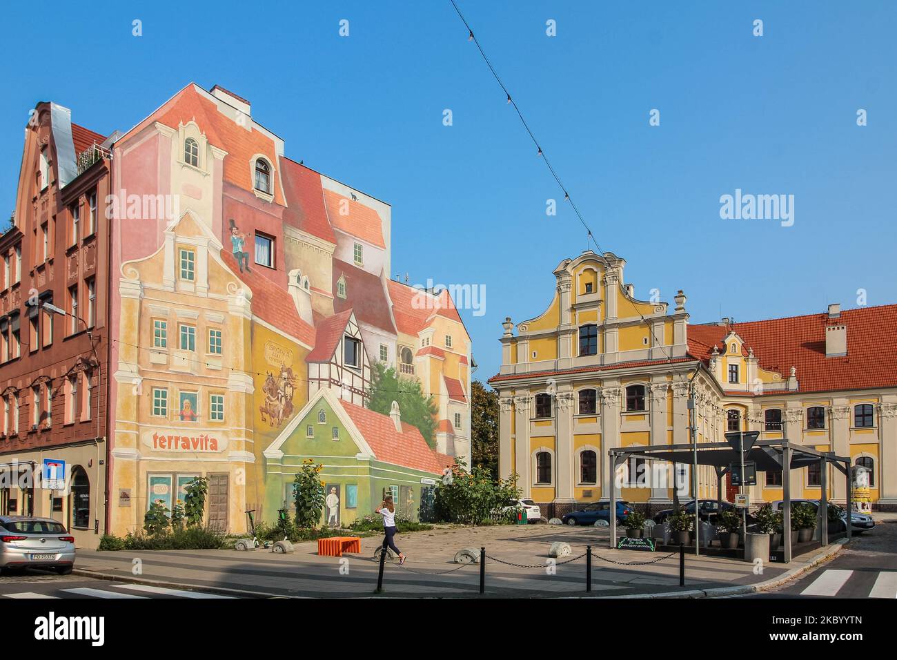Giant mural named ' Srodka story with a bugler on the roof and a cat in ...