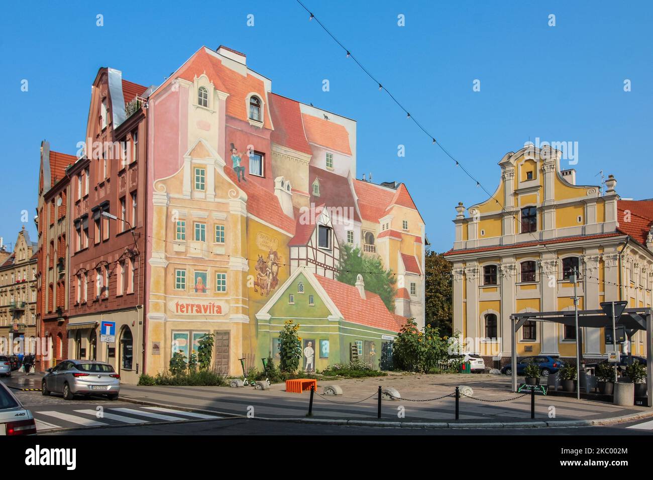 Giant mural named ' Srodka story with a bugler on the roof and a cat in ...