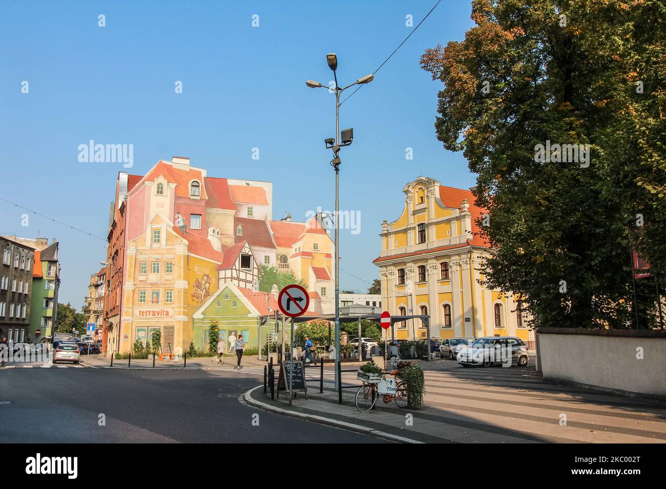Giant mural named ' Srodka story with a bugler on the roof and a cat in ...