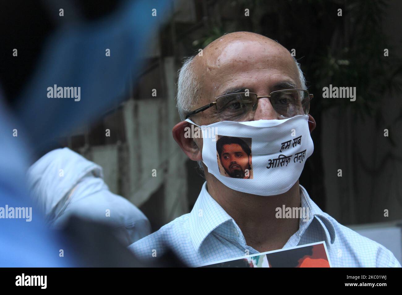 Harsh Mander, civil rights activist, wearing masks with faces of other ...