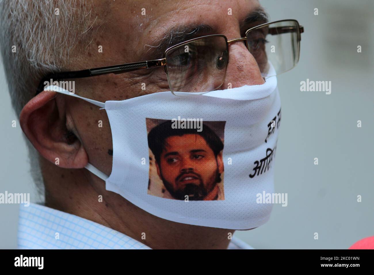 Harsh Mander, civil rights activist, wearing masks with faces of other ...