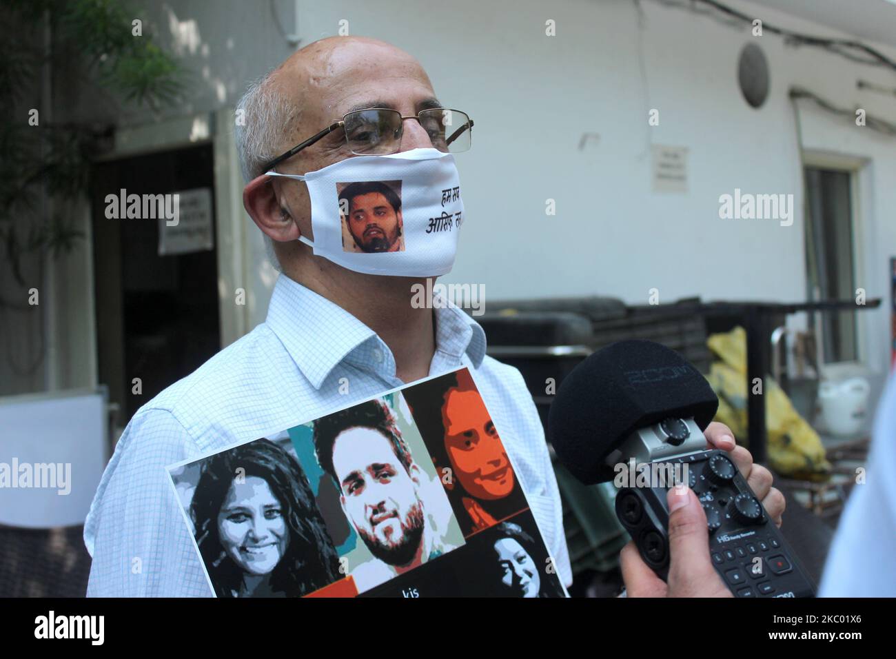 Harsh Mander, civil rights activist, wearing masks with faces of other ...