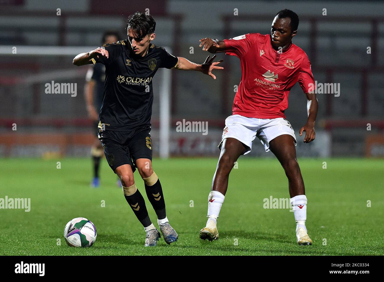 Morecambe's Carlos Mendes Gomes and Oldham's Callum Whelan in action ...