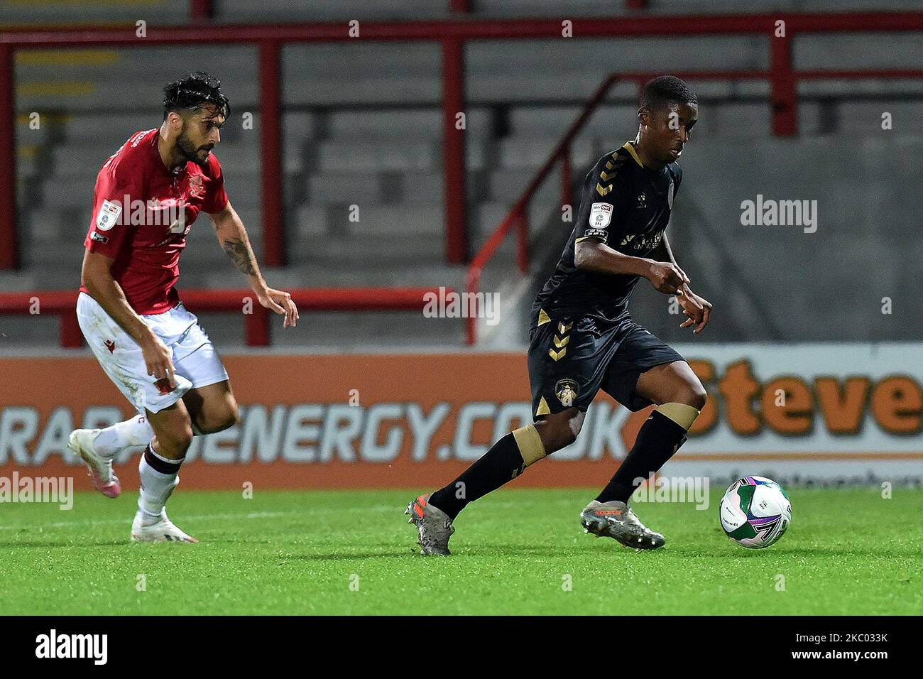 Morecambe's Adam Phillips and Oldham's Dylan Fage in action during the ...