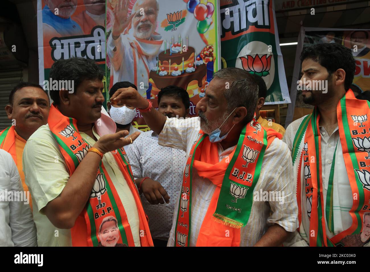Supporter of India's Bharatiya Janata Party (BJP) distribute sweet ...