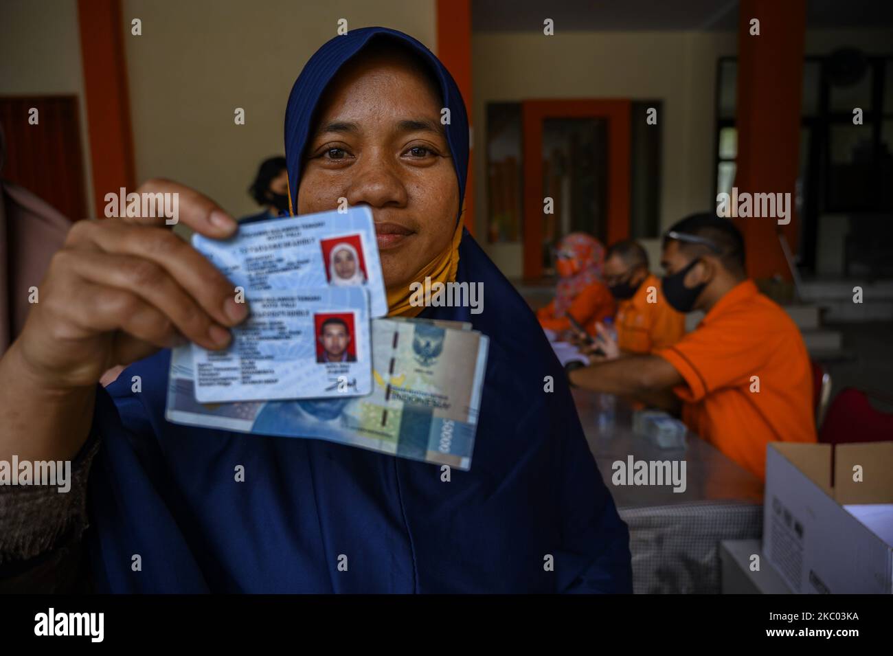 A resident shows the Cash Social Assistance (BST) money he just ...