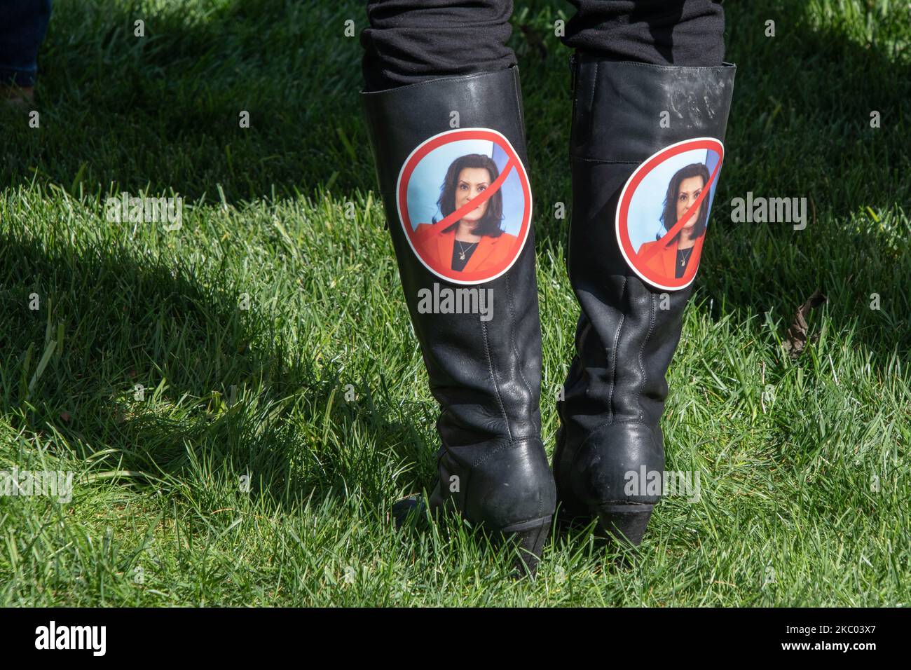 A gun rights advocate wears anti-Governor Gretchen Whitmer stickers on ...