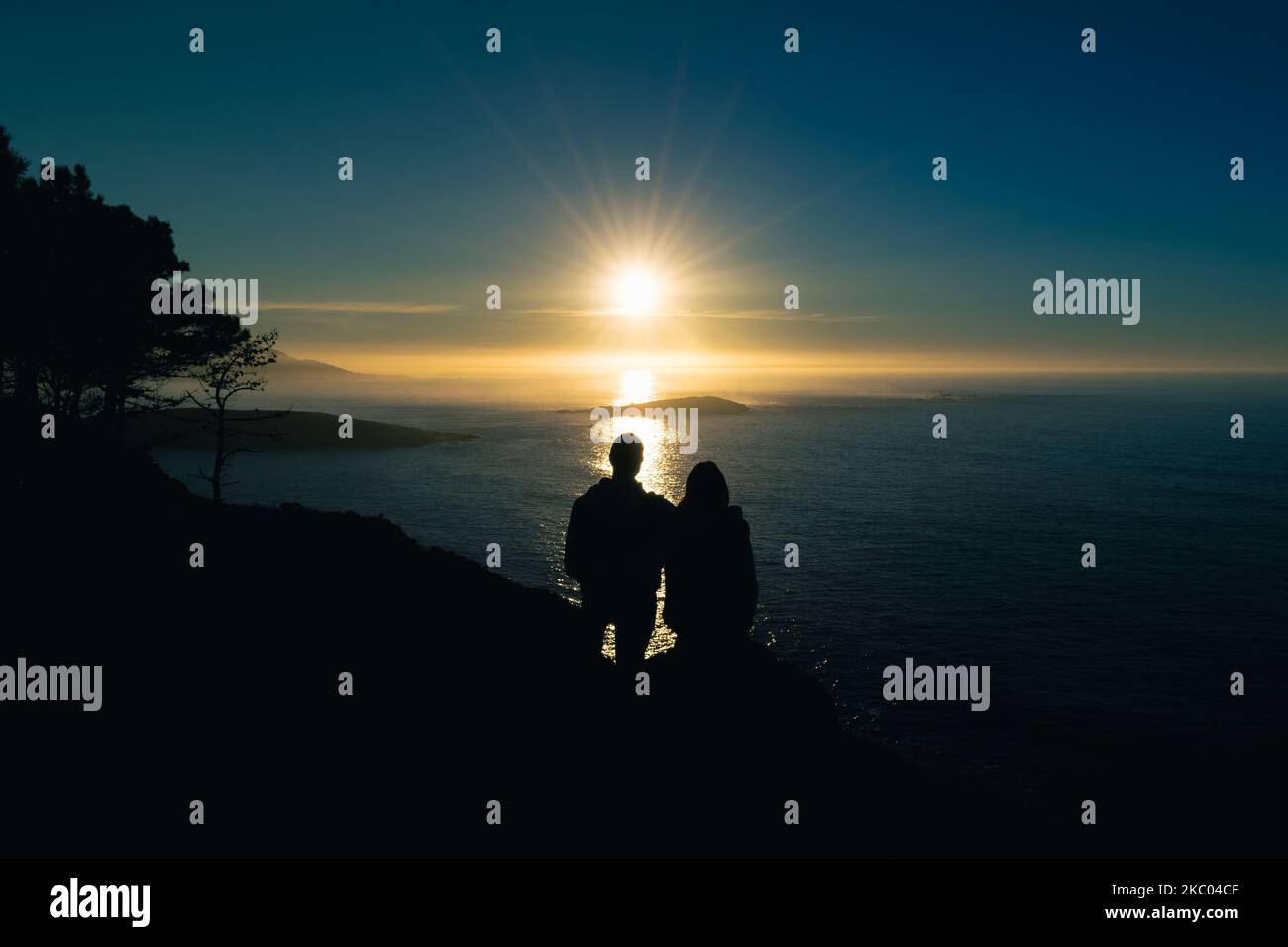 Young couple standing on a mountain top hi-res stock photography and ...