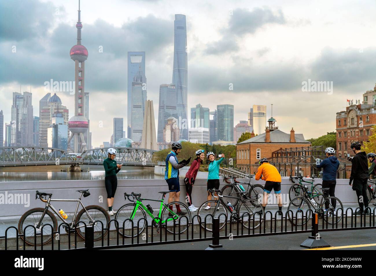 Shanghai. 4th Nov, 2022. Cyclists take photos by the Suzhou Creek in ...