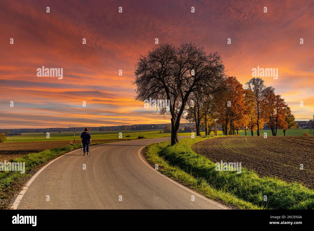 Woman walking on rural road hi-res stock photography and images - Alamy